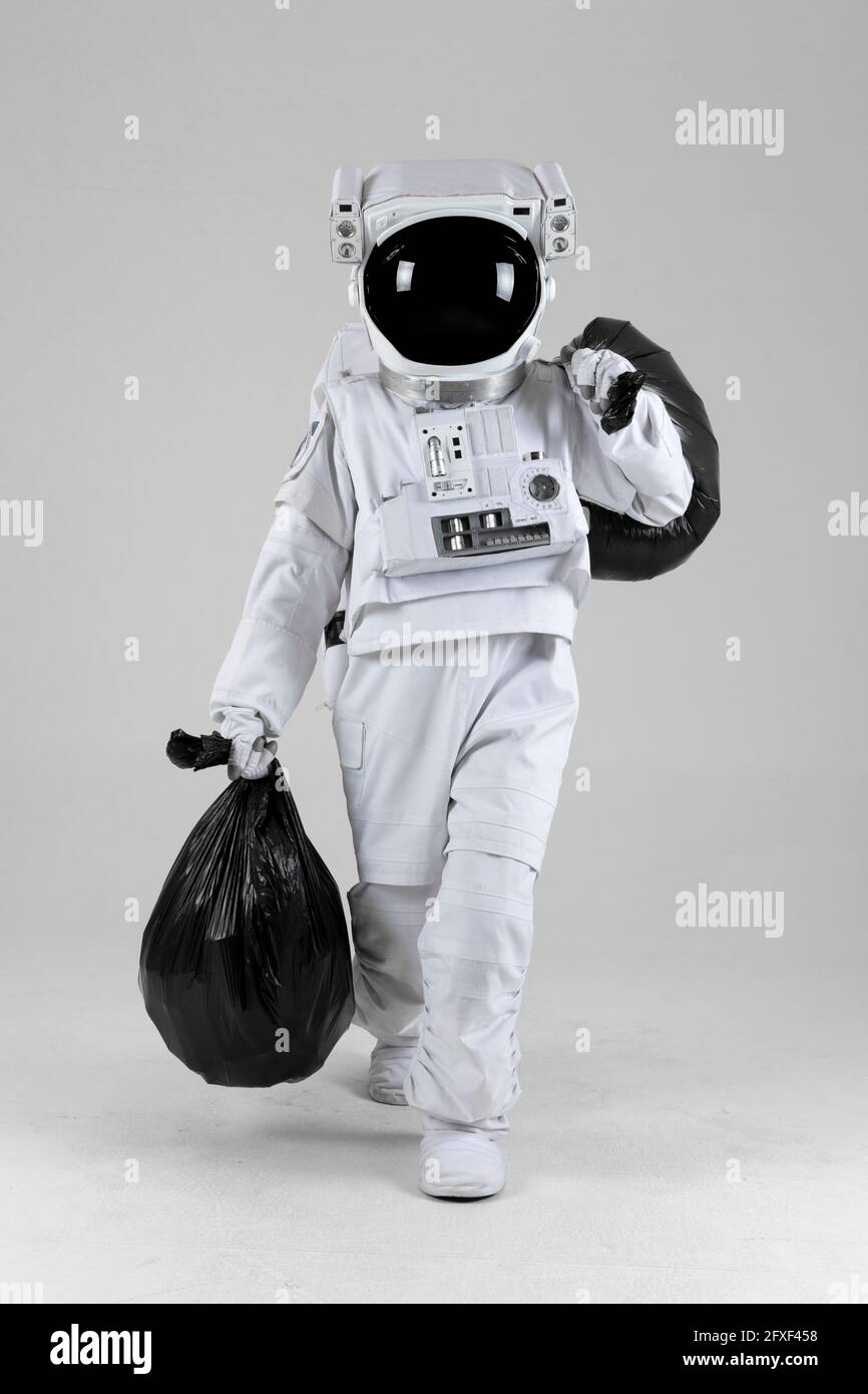 Astronaut with garbage bags, white background Stock Photo - Alamy