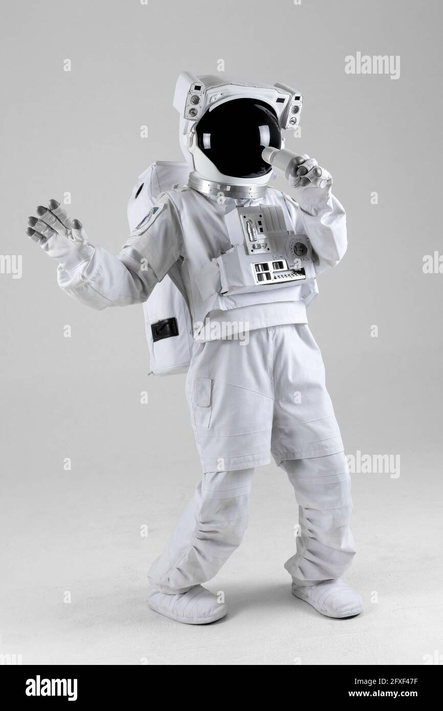 Astronaut singing and dancing with microphone, white background Stock ...