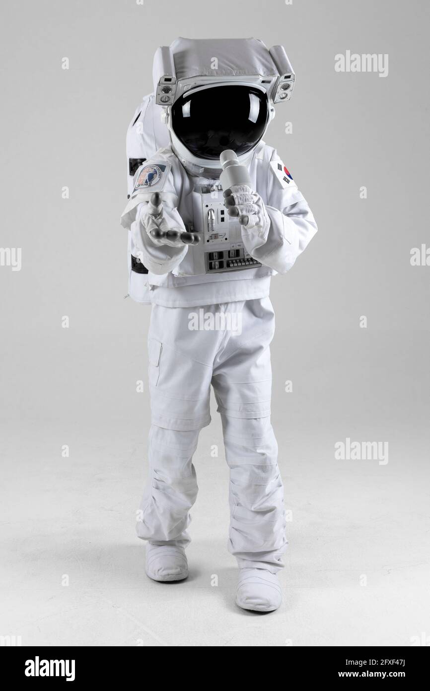 Astronaut singing and dancing with microphone, white background Stock ...