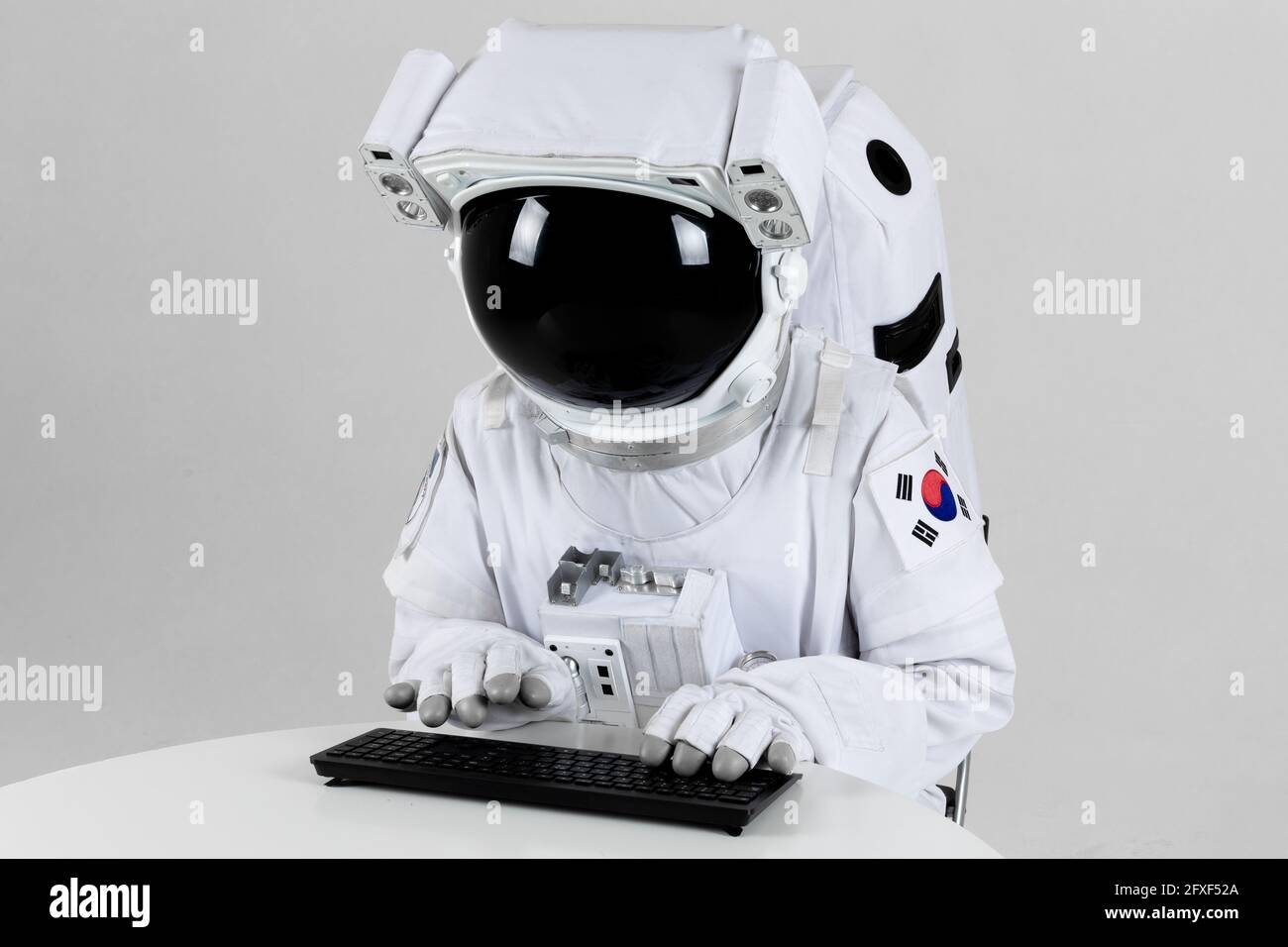 Astronaut typing, white background Stock Photo - Alamy