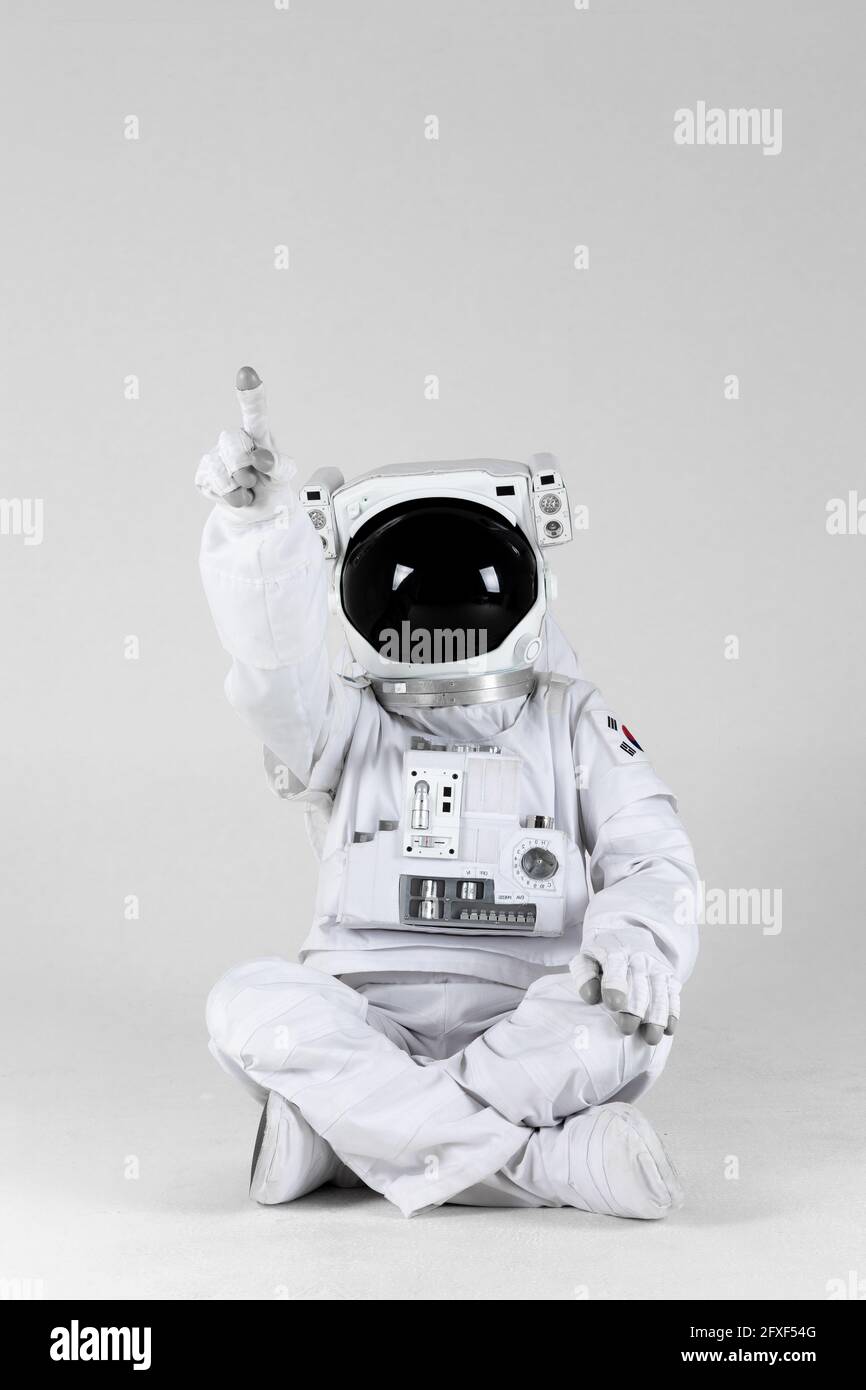 Astronaut pointing one side, white background Stock Photo - Alamy