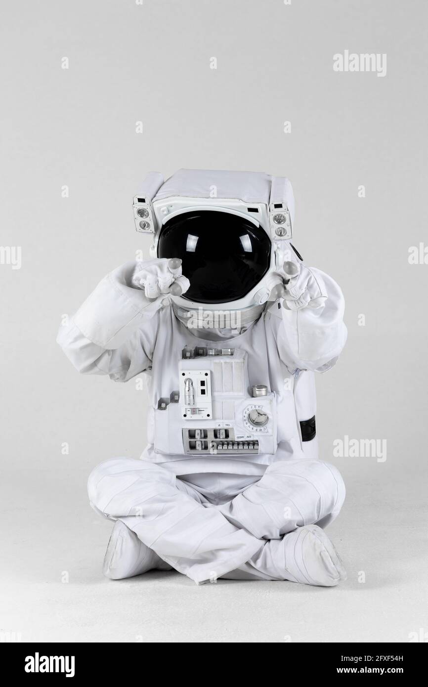 Astronaut pointing one side, white background Stock Photo - Alamy