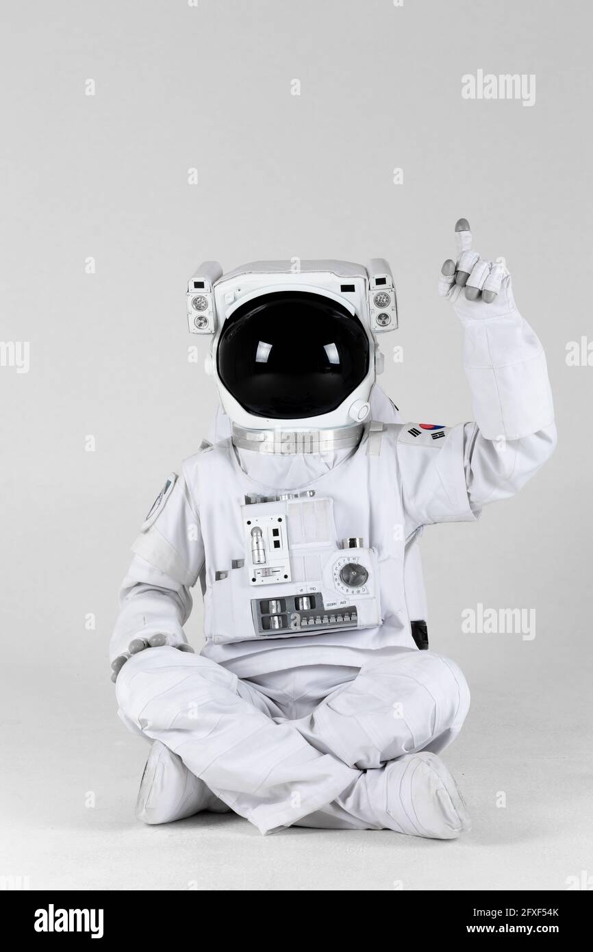 Astronaut pointing one side, white background Stock Photo - Alamy