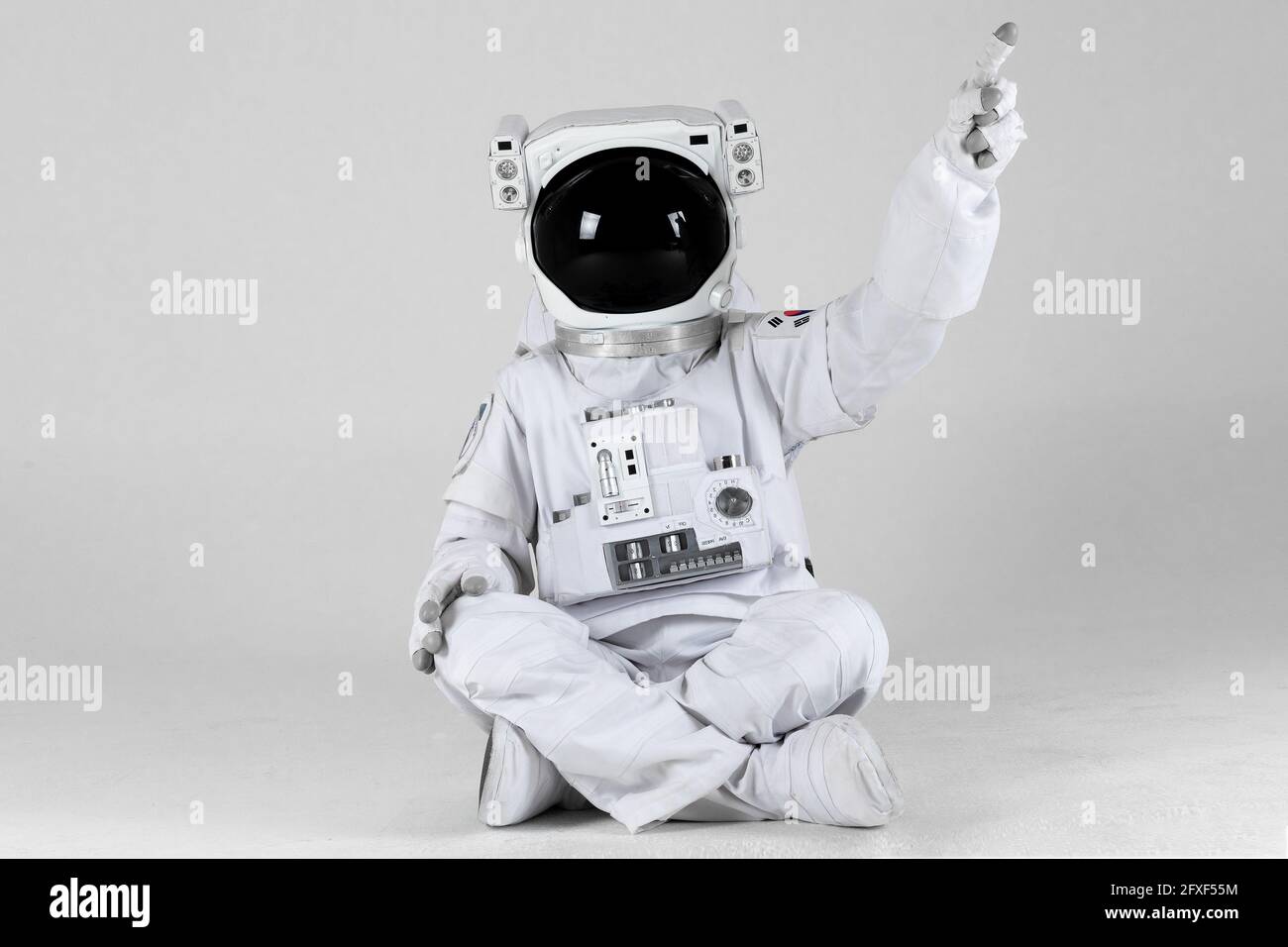 Astronaut pointing one side, white background Stock Photo - Alamy