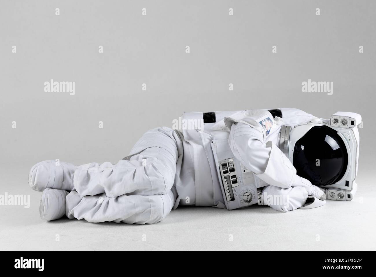 Astronaut lying on side, white background Stock Photo - Alamy