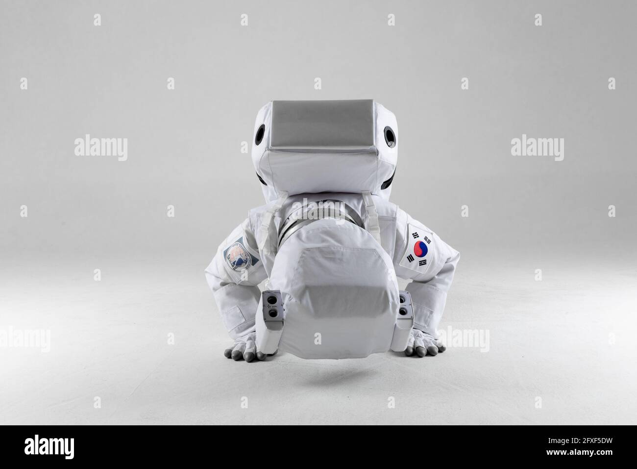 Astronaut doing exercise, white background Stock Photo - Alamy