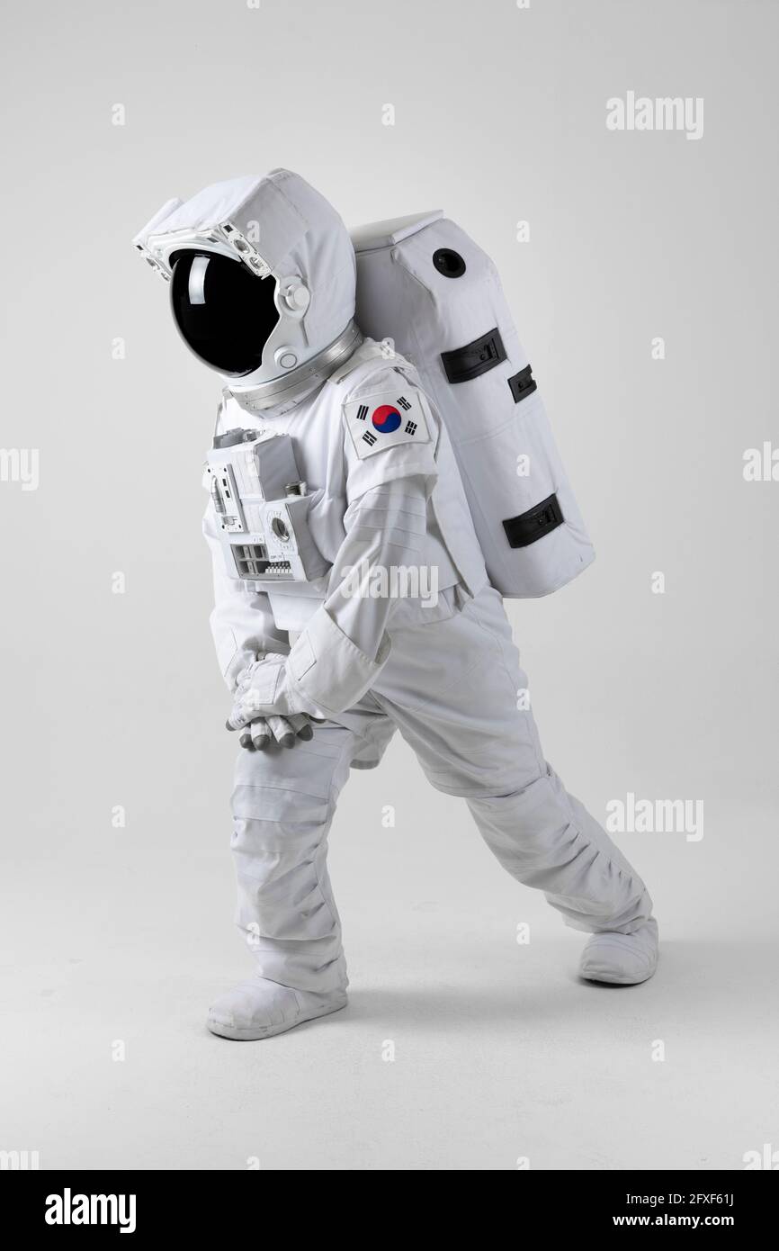 Astronaut stretching before exercise, white background Stock Photo - Alamy