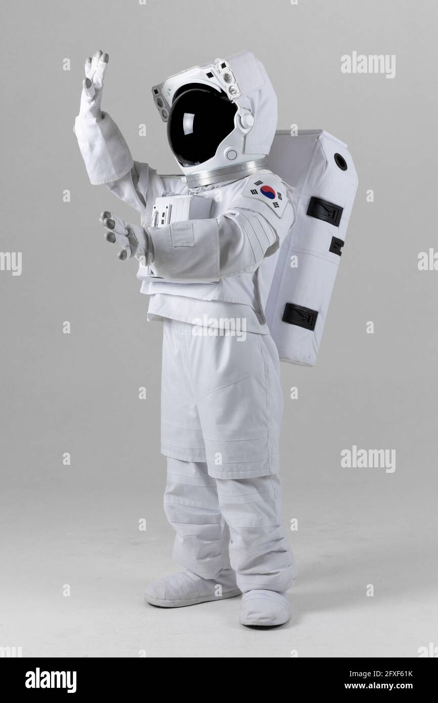 astronaut touching empty space, white background Stock Photo - Alamy