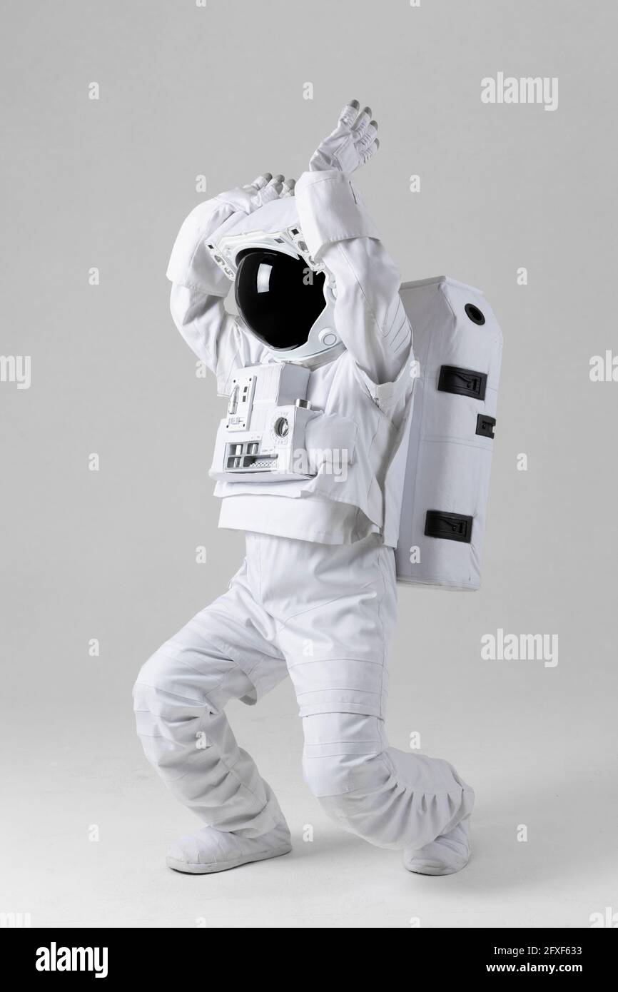 Astronaut holding a large object, white background Stock Photo - Alamy