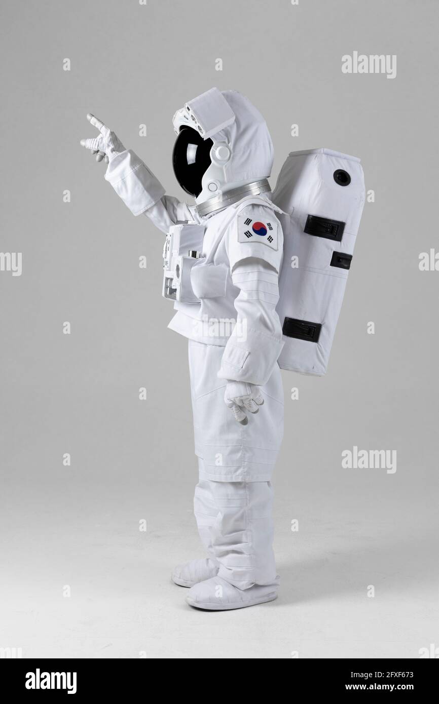 astronaut touching empty space, white background Stock Photo - Alamy
