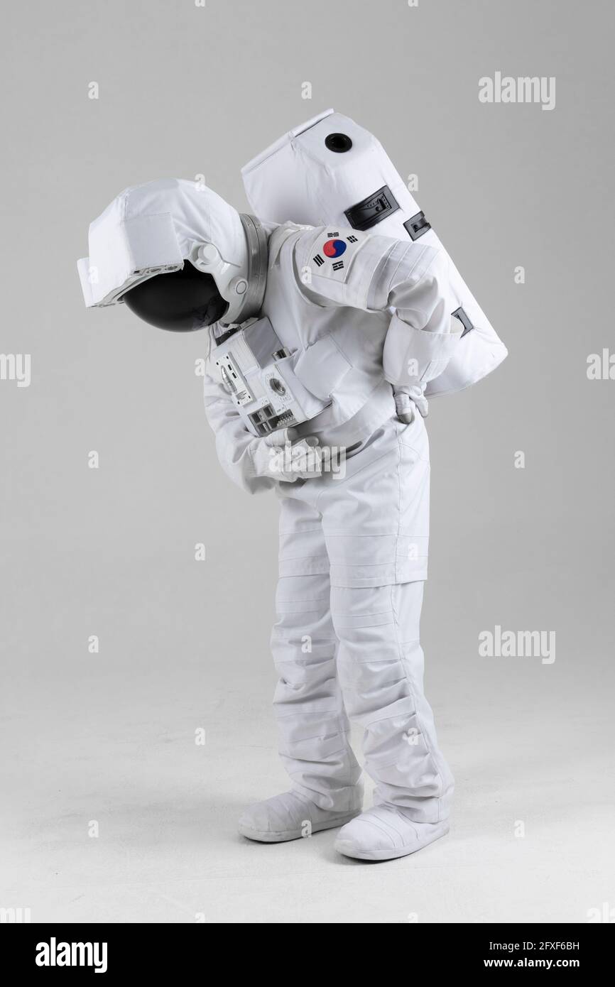 astronaut with back pain, white background Stock Photo - Alamy