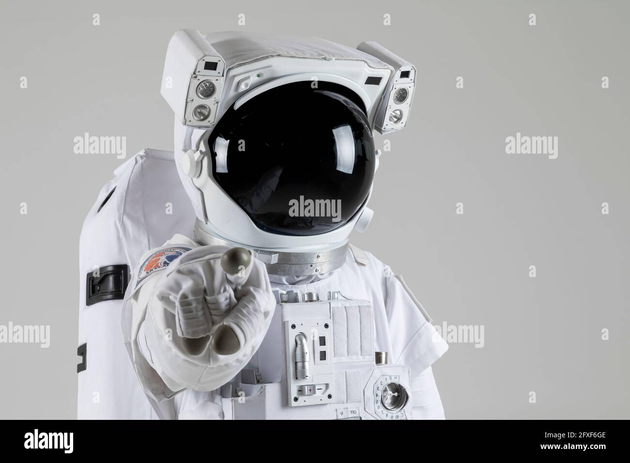 Astronaut pointing using finger, white background Stock Photo - Alamy