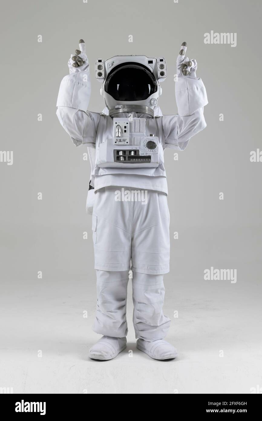 Astronaut pointing up with finger, white background Stock Photo - Alamy