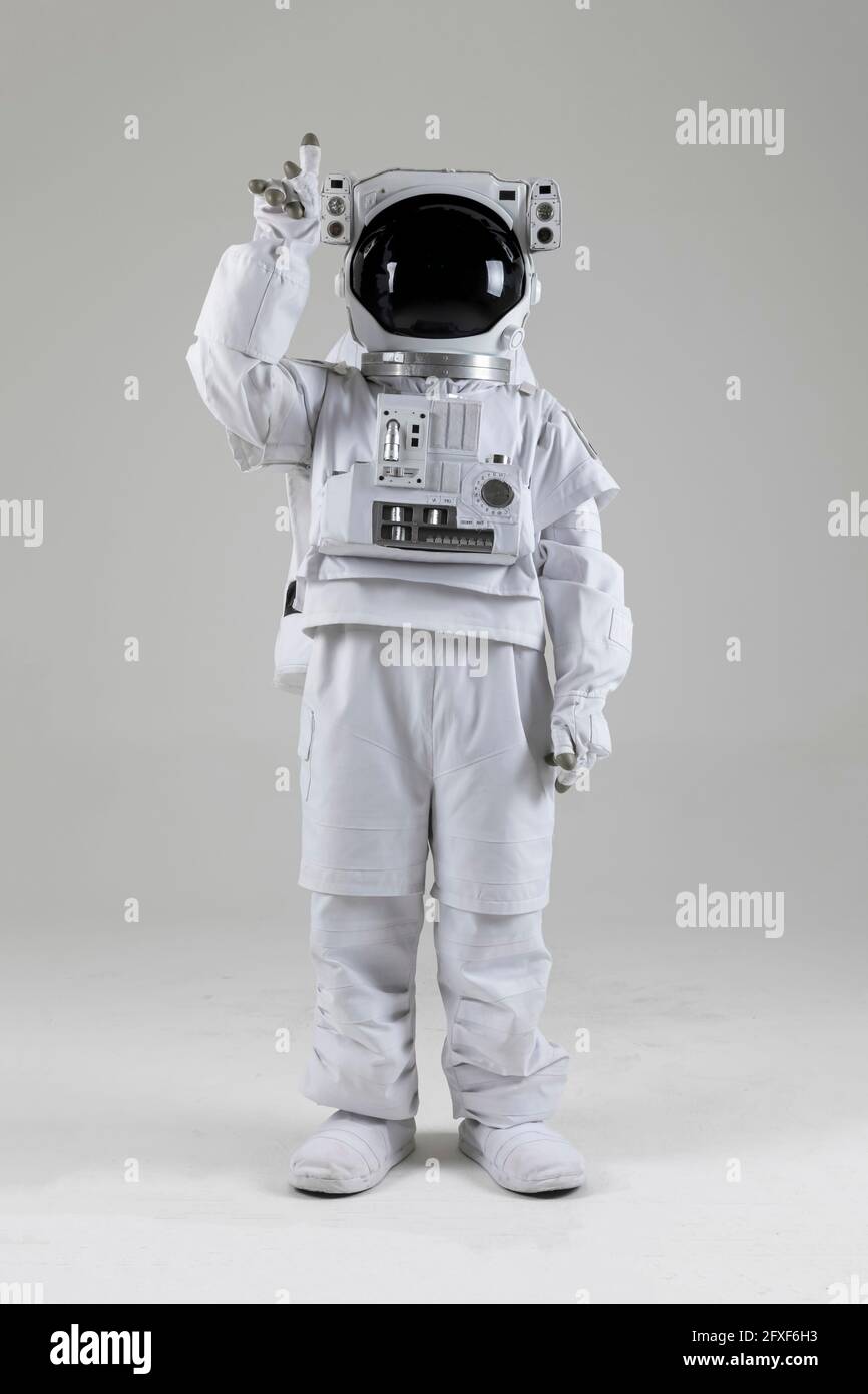 Astronaut pointing up with finger, white background Stock Photo - Alamy