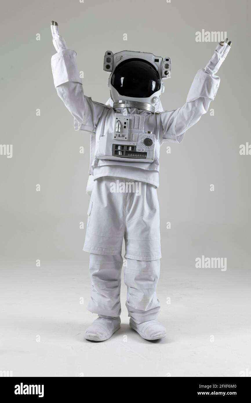 Astronaut holding both hands, white background Stock Photo - Alamy
