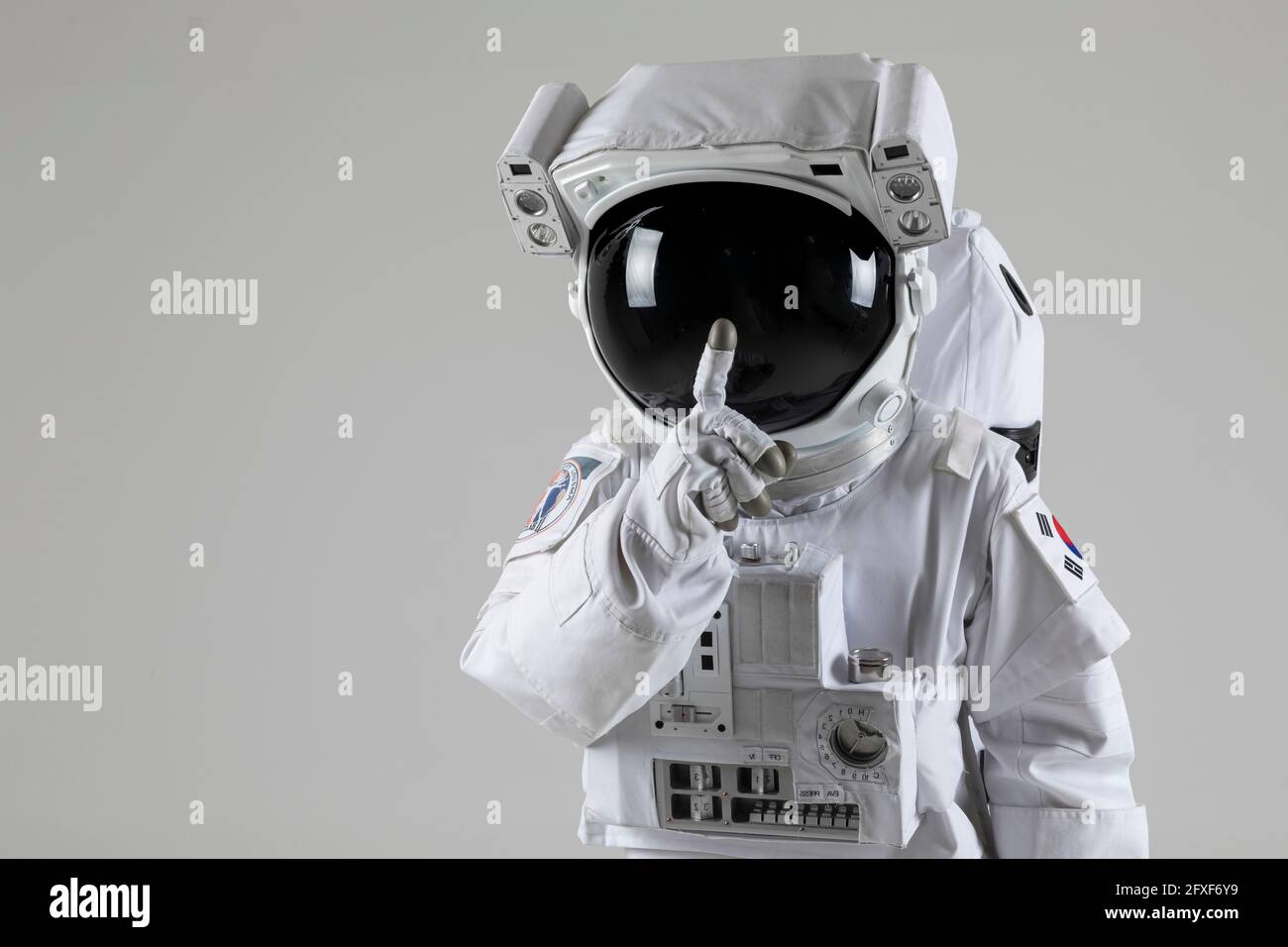 Astronaut asking for silence, white background Stock Photo - Alamy