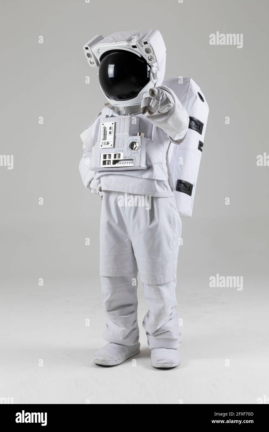 Astronaut, pointing using finger, white background Stock Photo - Alamy