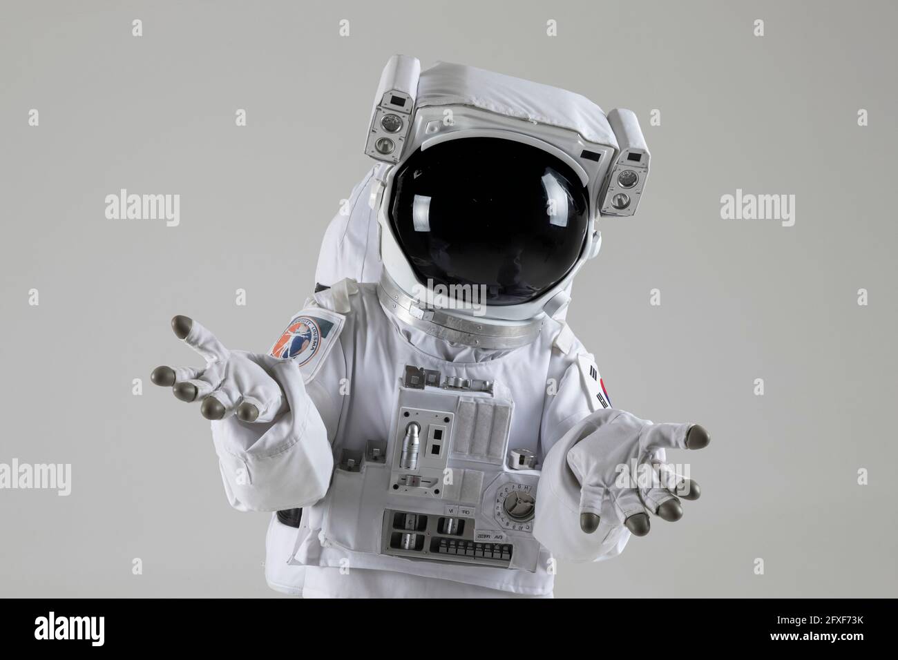 Astronaut holding both hands, white background Stock Photo - Alamy