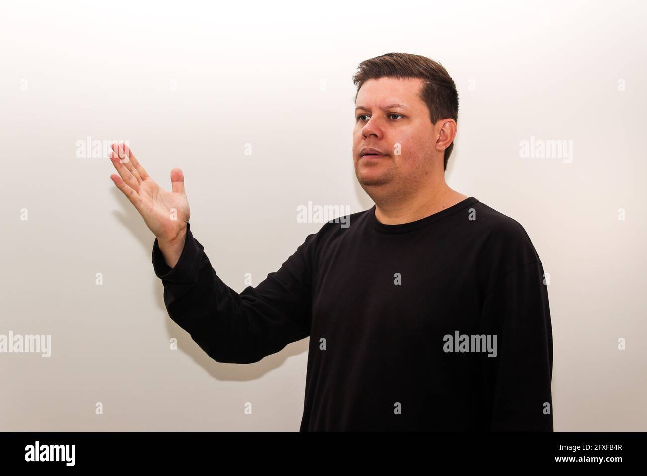 Angry Brazilian male raising his hand Stock Photo - Alamy