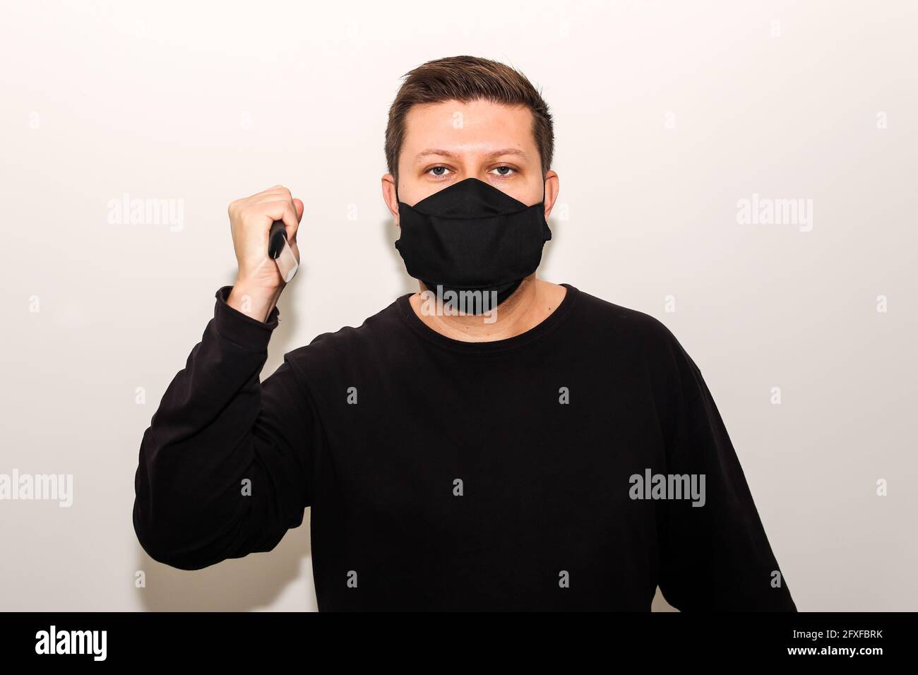 Serious Brazilian male with a face mask threatening with a knife Stock ...