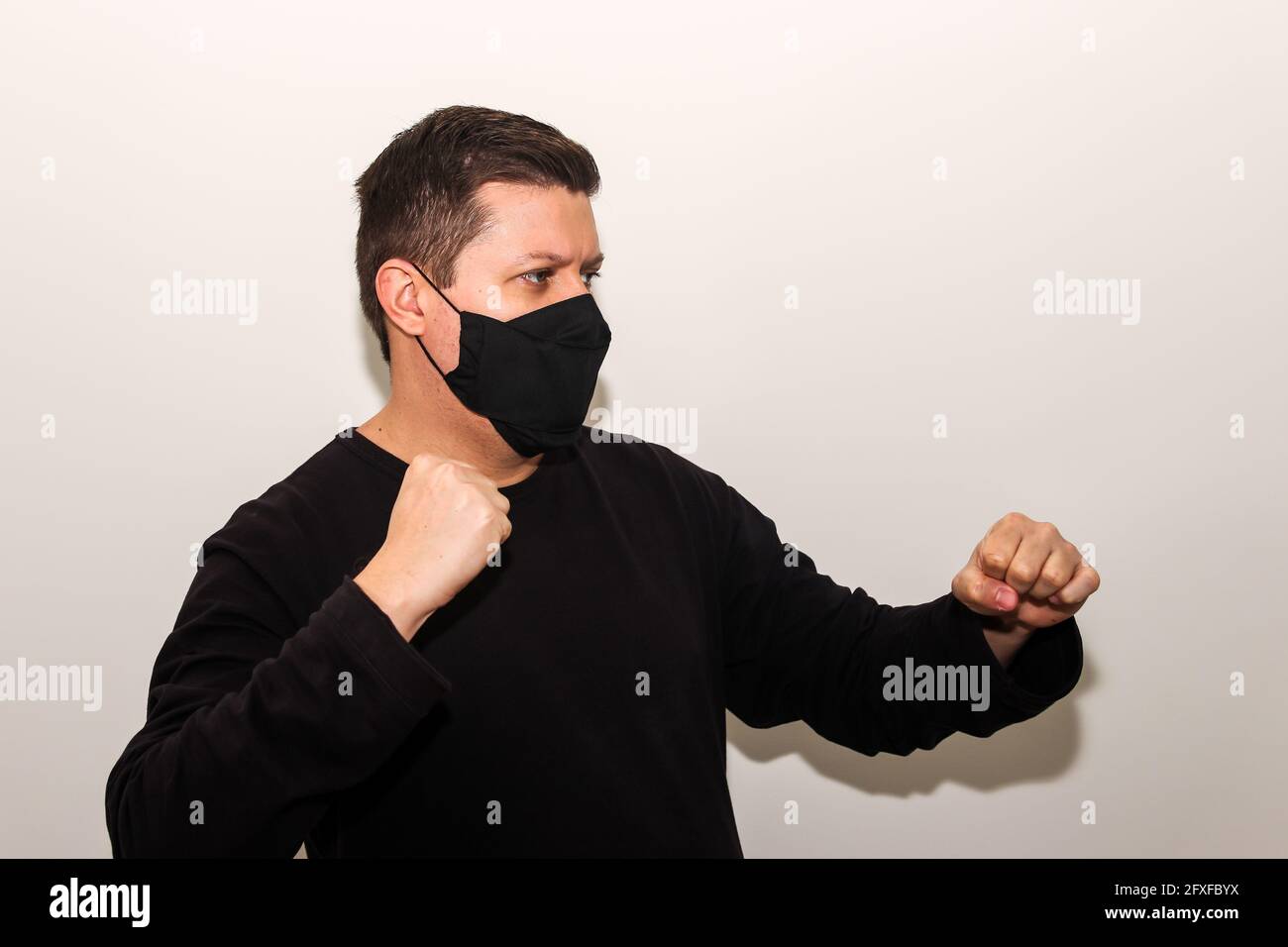 Brazilian male with face mask showing boxing sign Stock Photo - Alamy