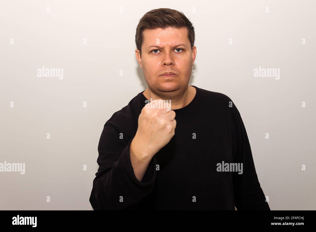 Angry Brazilian male showing fist sign Stock Photo - Alamy