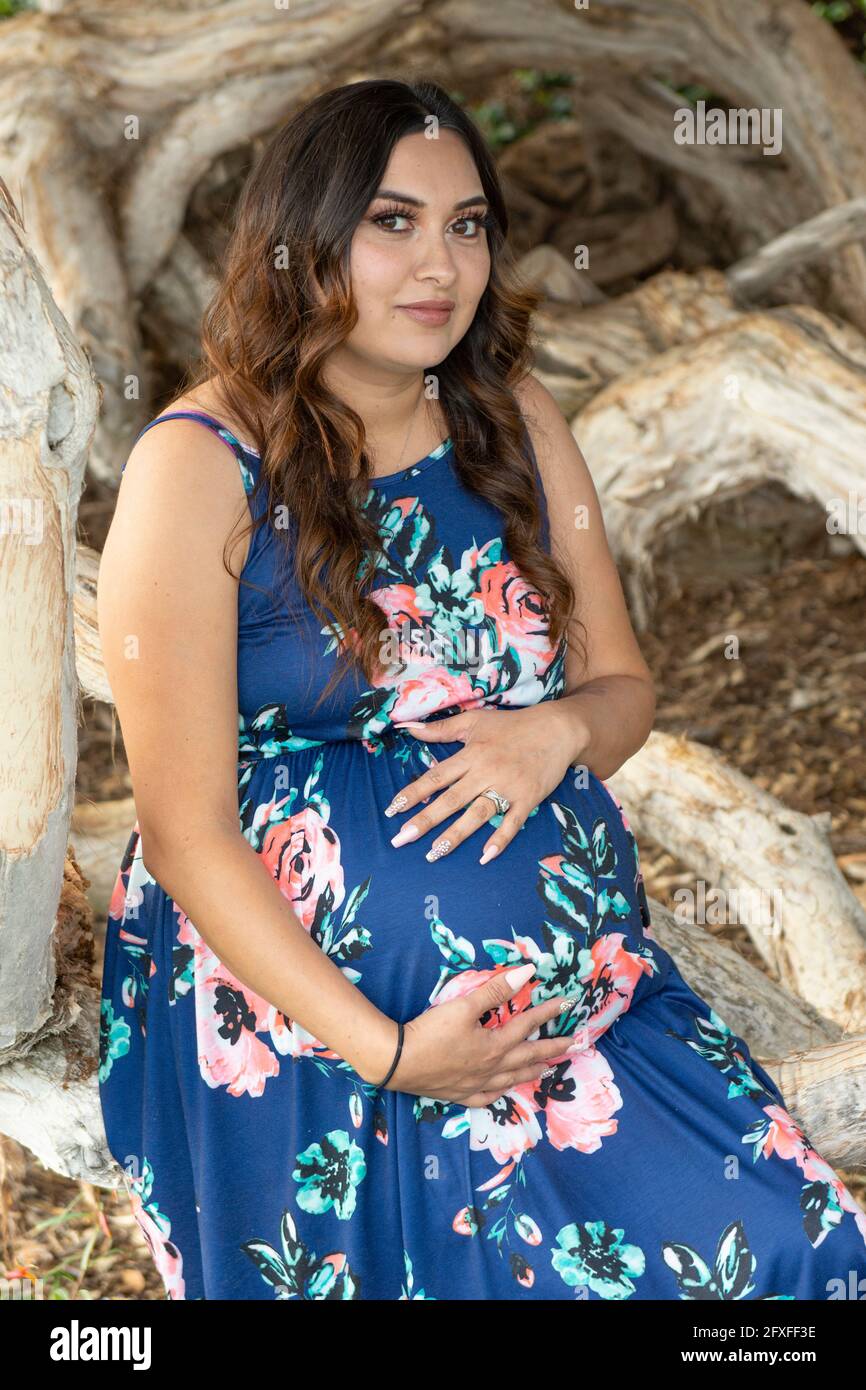 A 32 year old Latina woman with her family, who are taking part in her ...