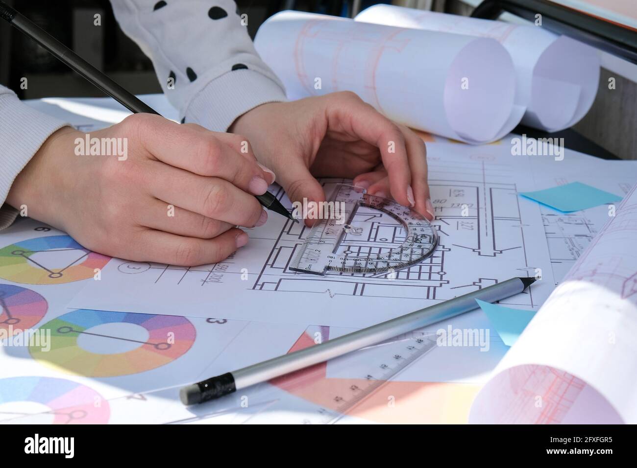 Hands use pencil with a protractor. Architectural Project drawings with ...