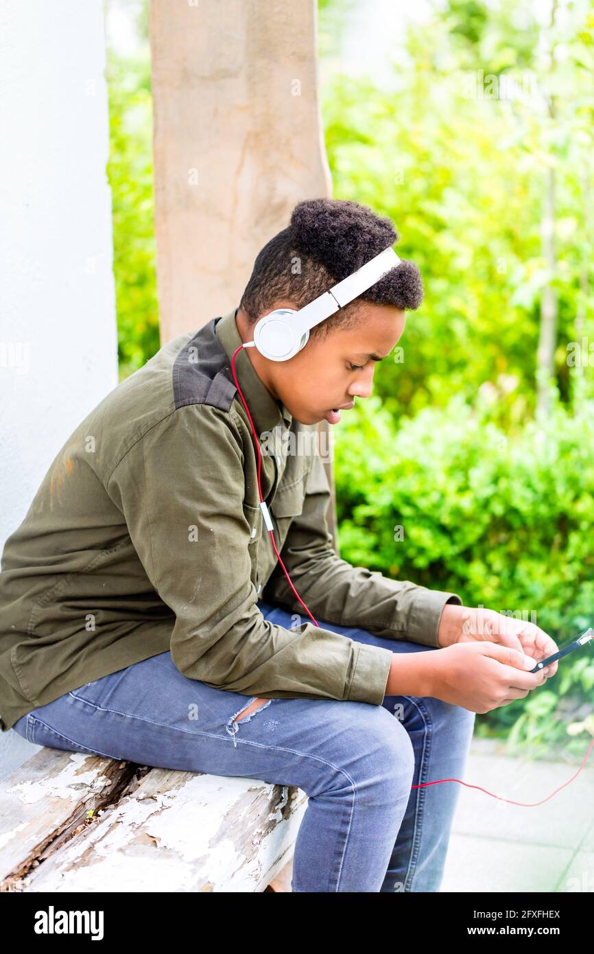 Black boy listening to music with headphones Stock Photo - Alamy