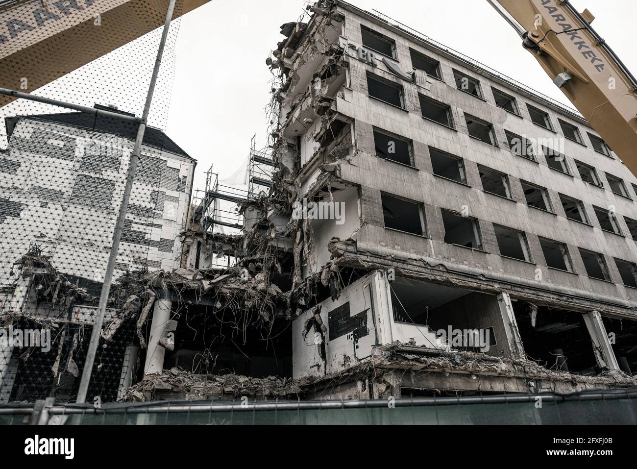 Low angle view of a damaged urban building to be demolished with a ...