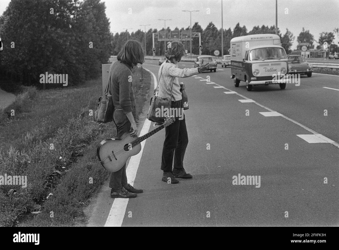 Two boys stand hitchhiking hi-res stock photography and images - Alamy