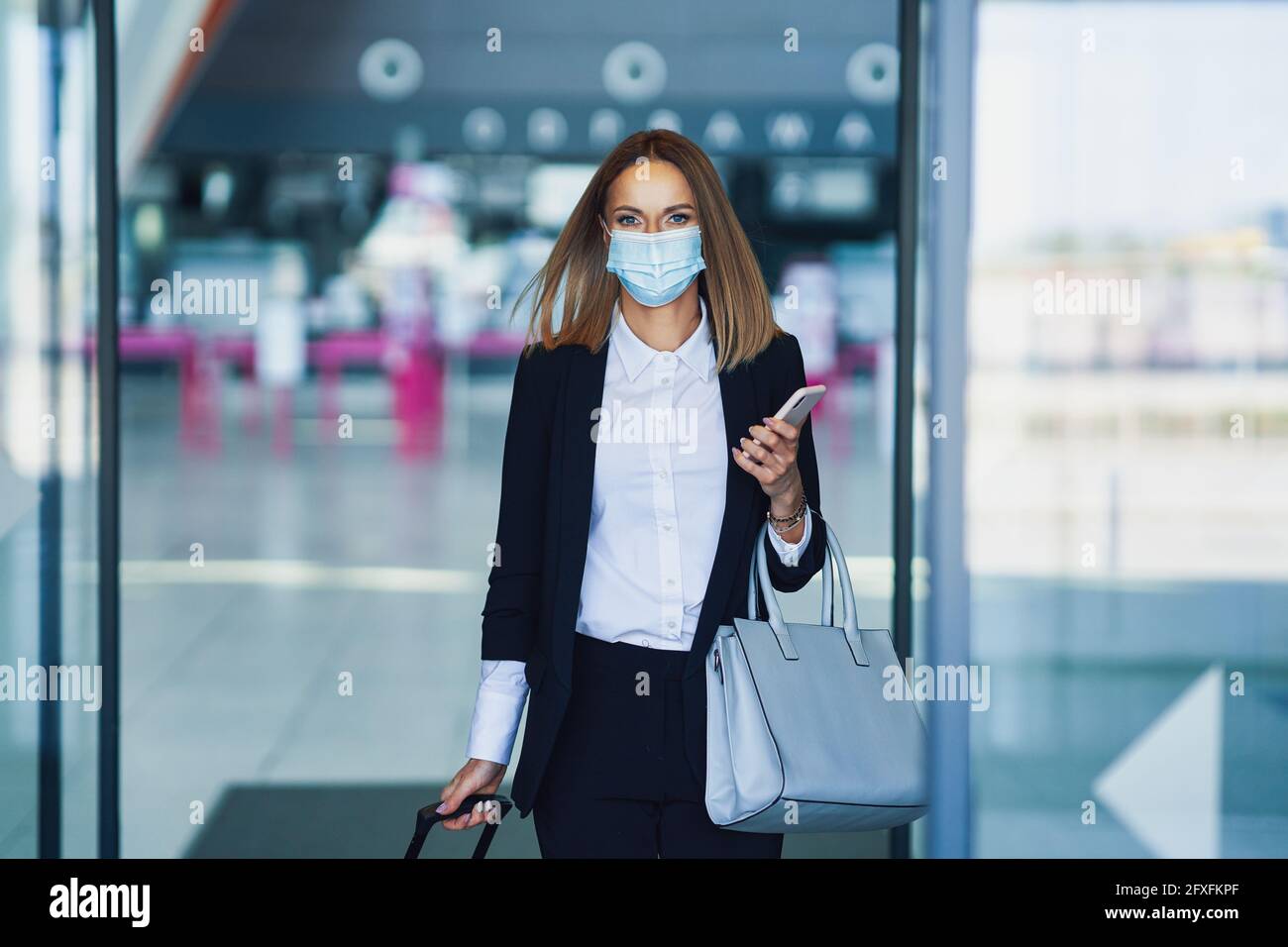 Adult female passenger at the airport Stock Photo - Alamy