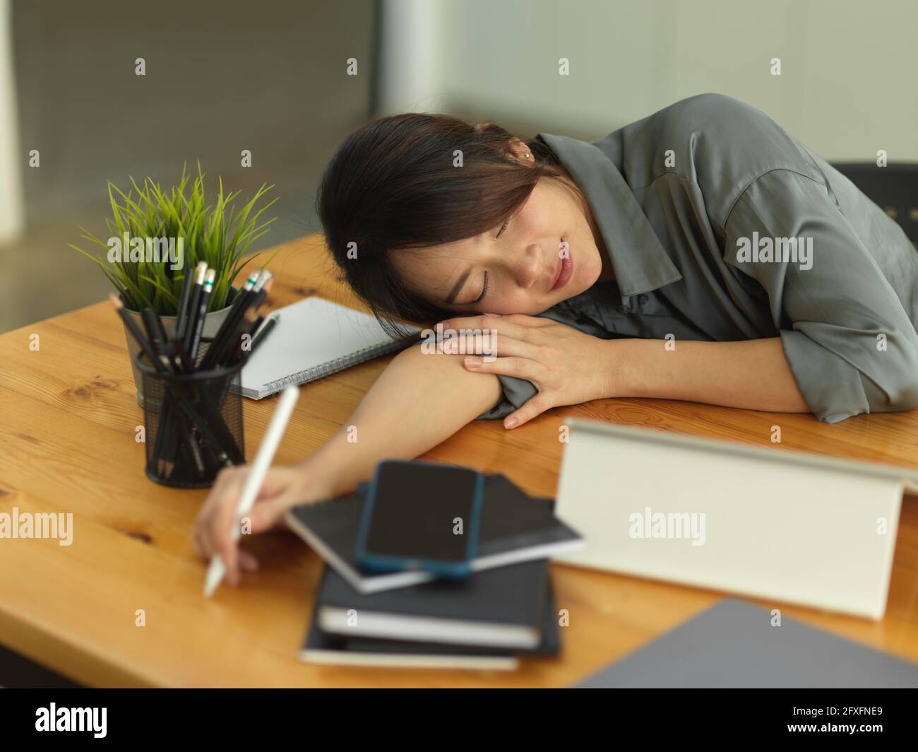 Portrait of female office worker take a nap when feeling tried while ...