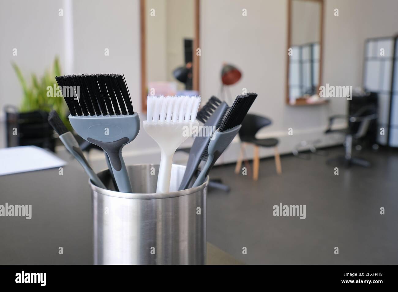 Hair dye brushes in a hairdressing salon. Hair coloring tools set ...