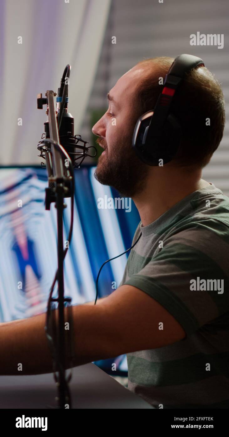 Professional digital player with headphones streaming video game with ...