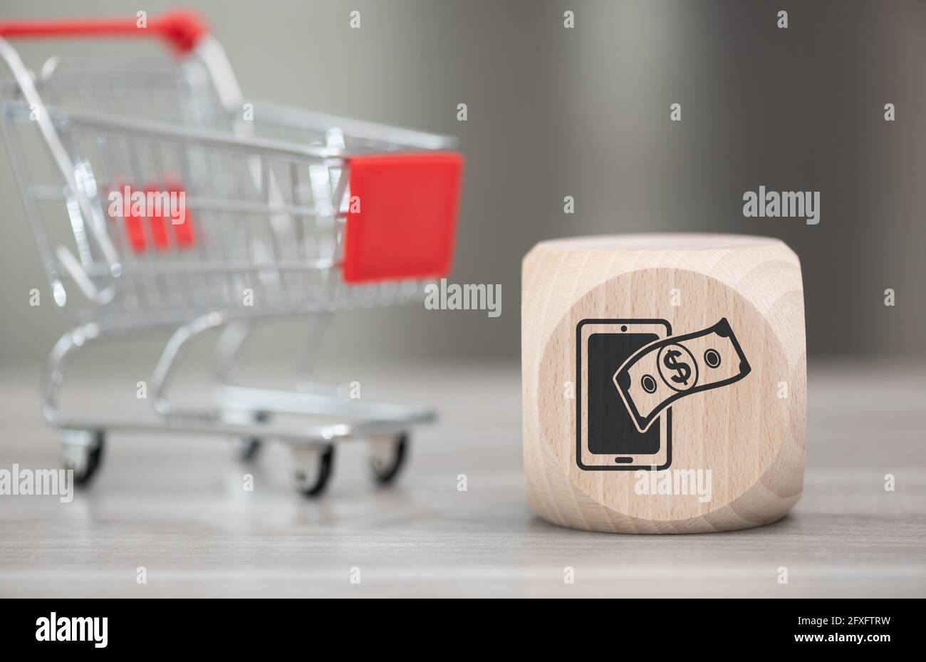 Wooden block with symbol of mobile payment concept and trolley on ...