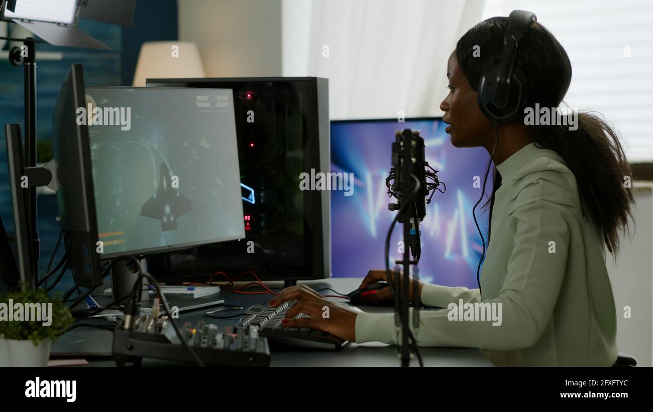 Furious pro afro american gamer talking into microphone for space ...