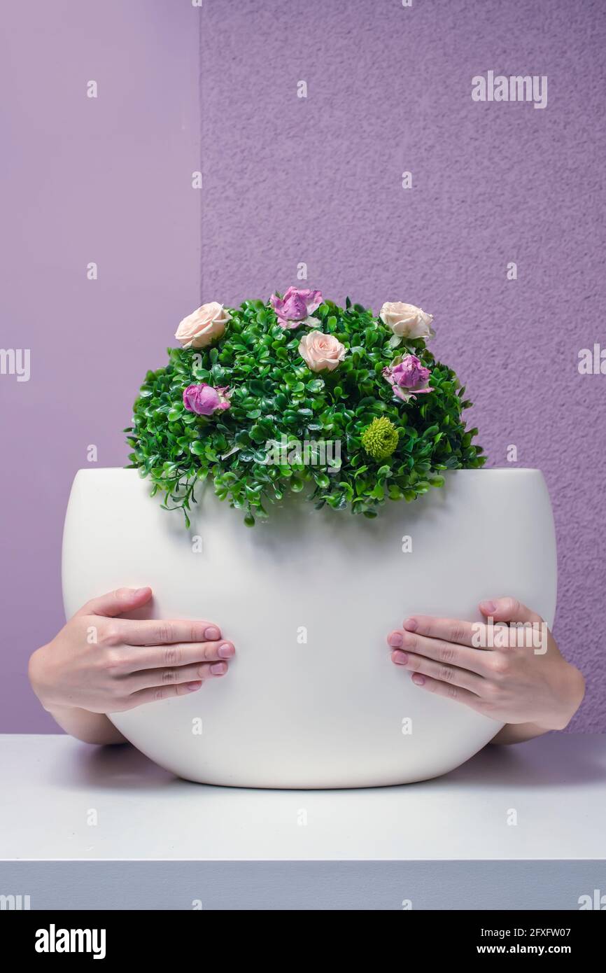 vase with Flowers and hands Stock Photo - Alamy