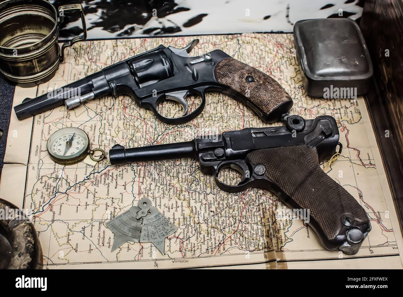 composition of two revolvers on the map Stock Photo - Alamy