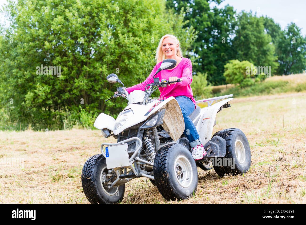 Woman driving off-road with quad bike or ATV Stock Photo - Alamy
