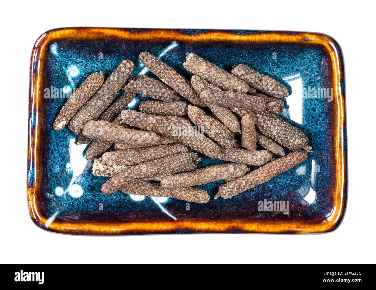 top view of java long pepper catkins in ceramic bowl cutout on white ...