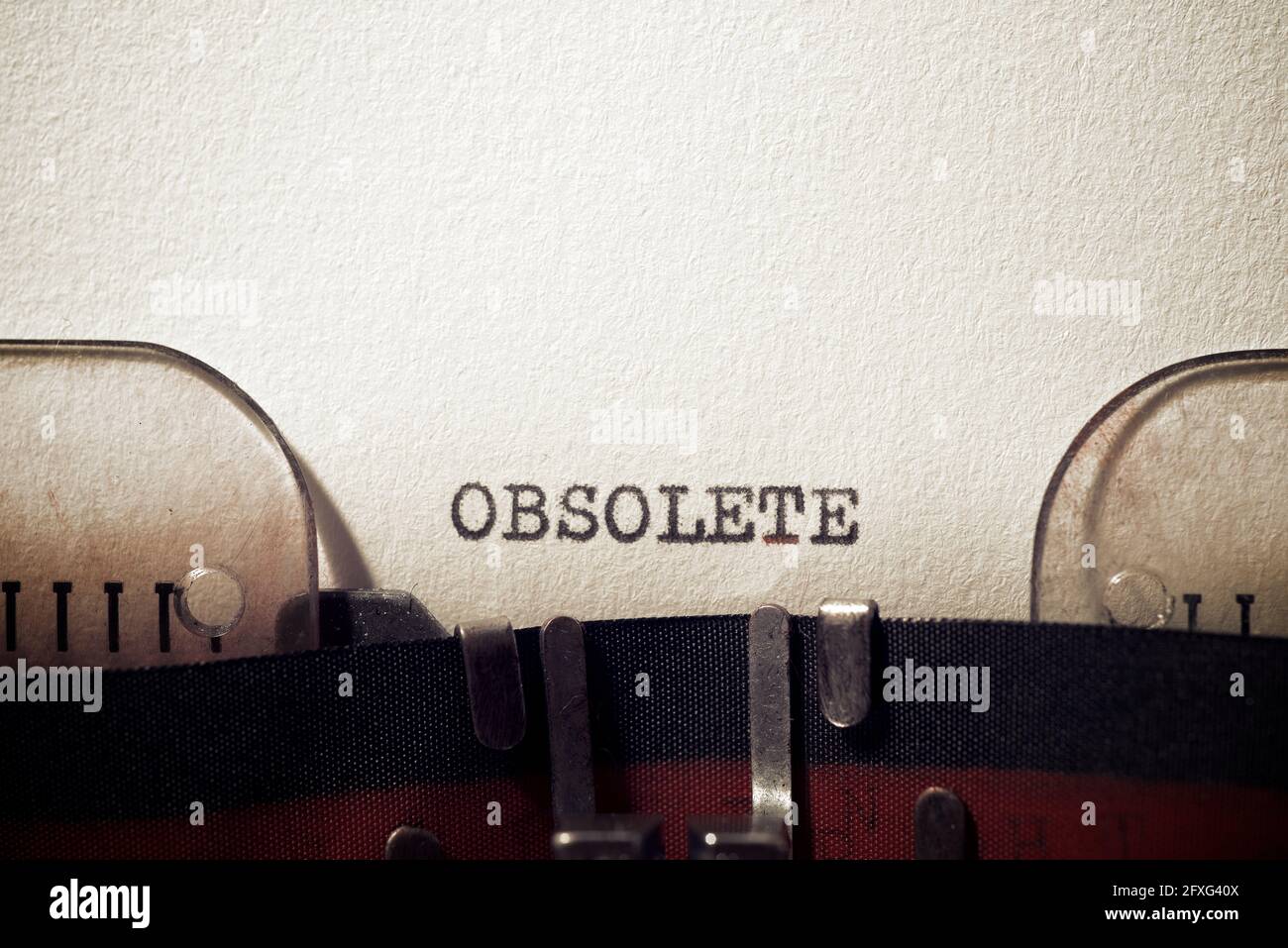 Obsolete word written with a typewriter Stock Photo - Alamy