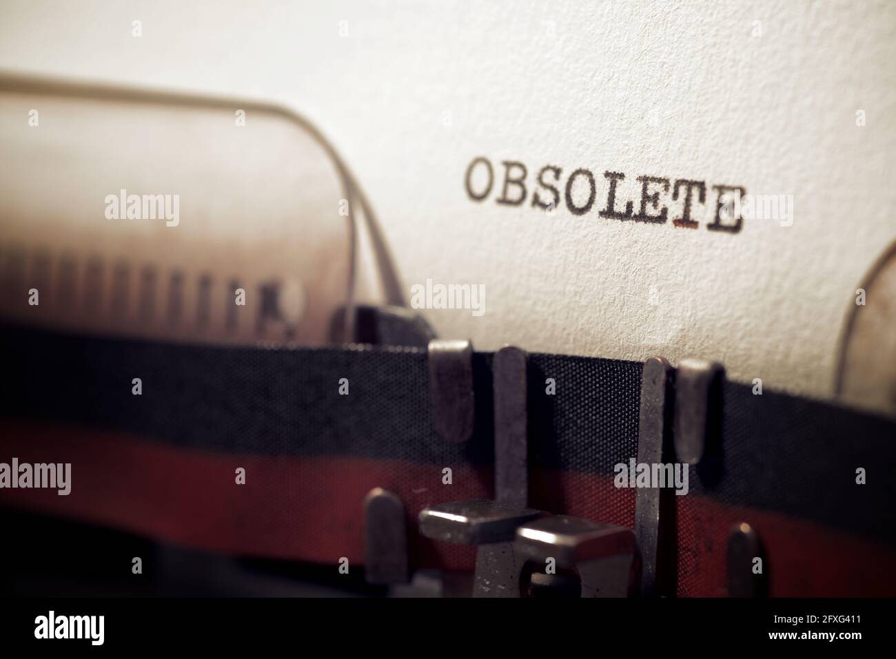 Obsolete word written with a typewriter Stock Photo - Alamy