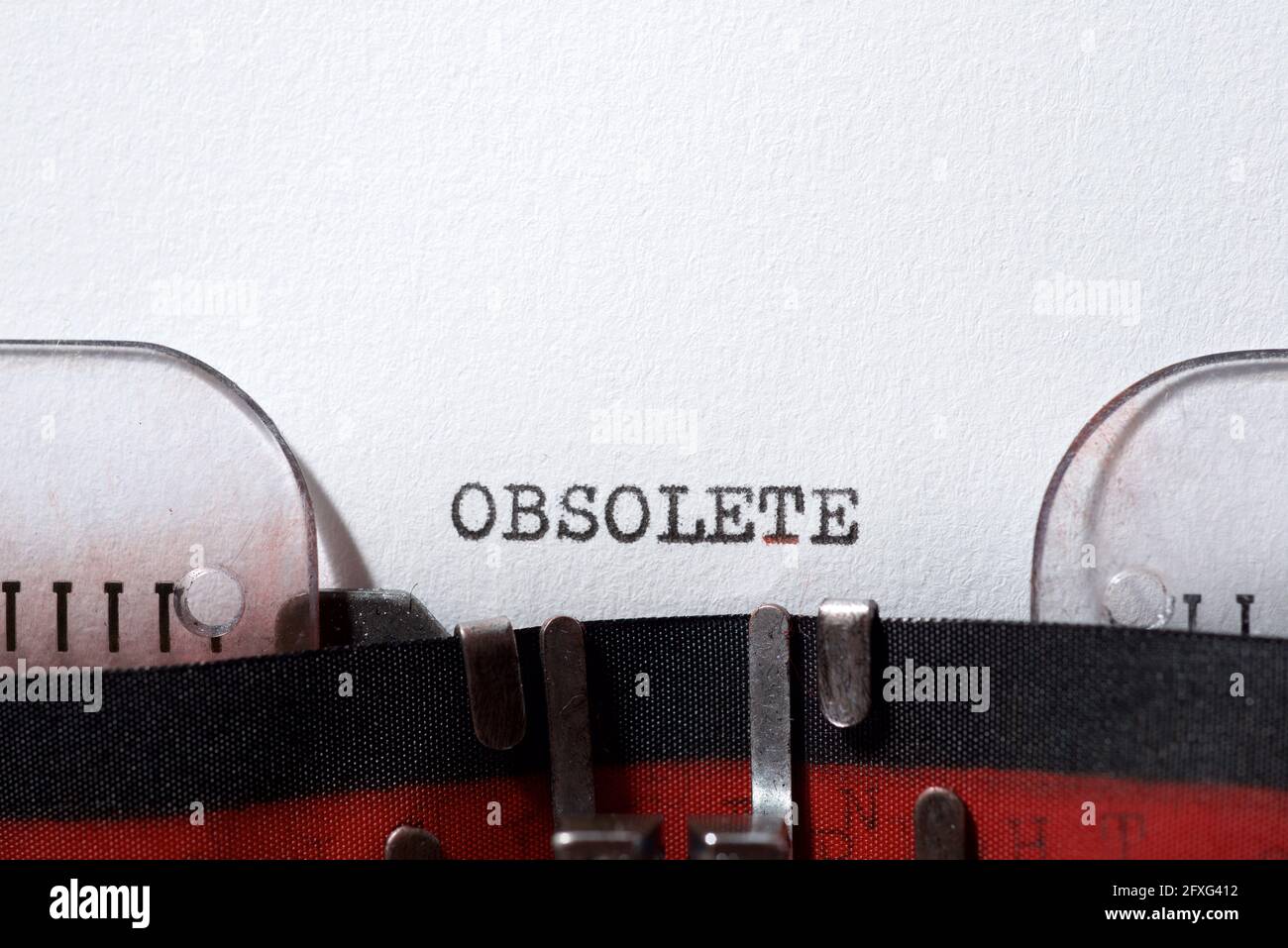 Obsolete word written with a typewriter Stock Photo - Alamy