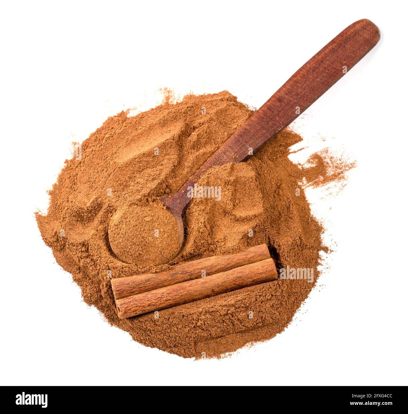 top view of wood spoon on pile of cassia bark and cinnamon powder on ...