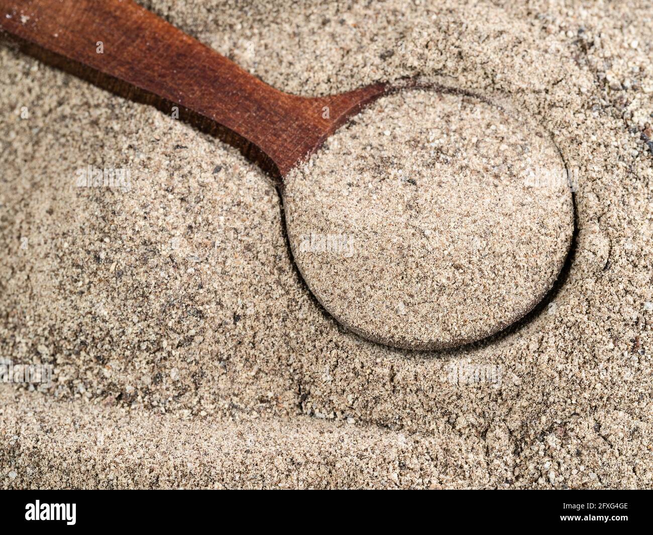 wooden spoon on pile of ground black pepper closeup Stock Photo - Alamy
