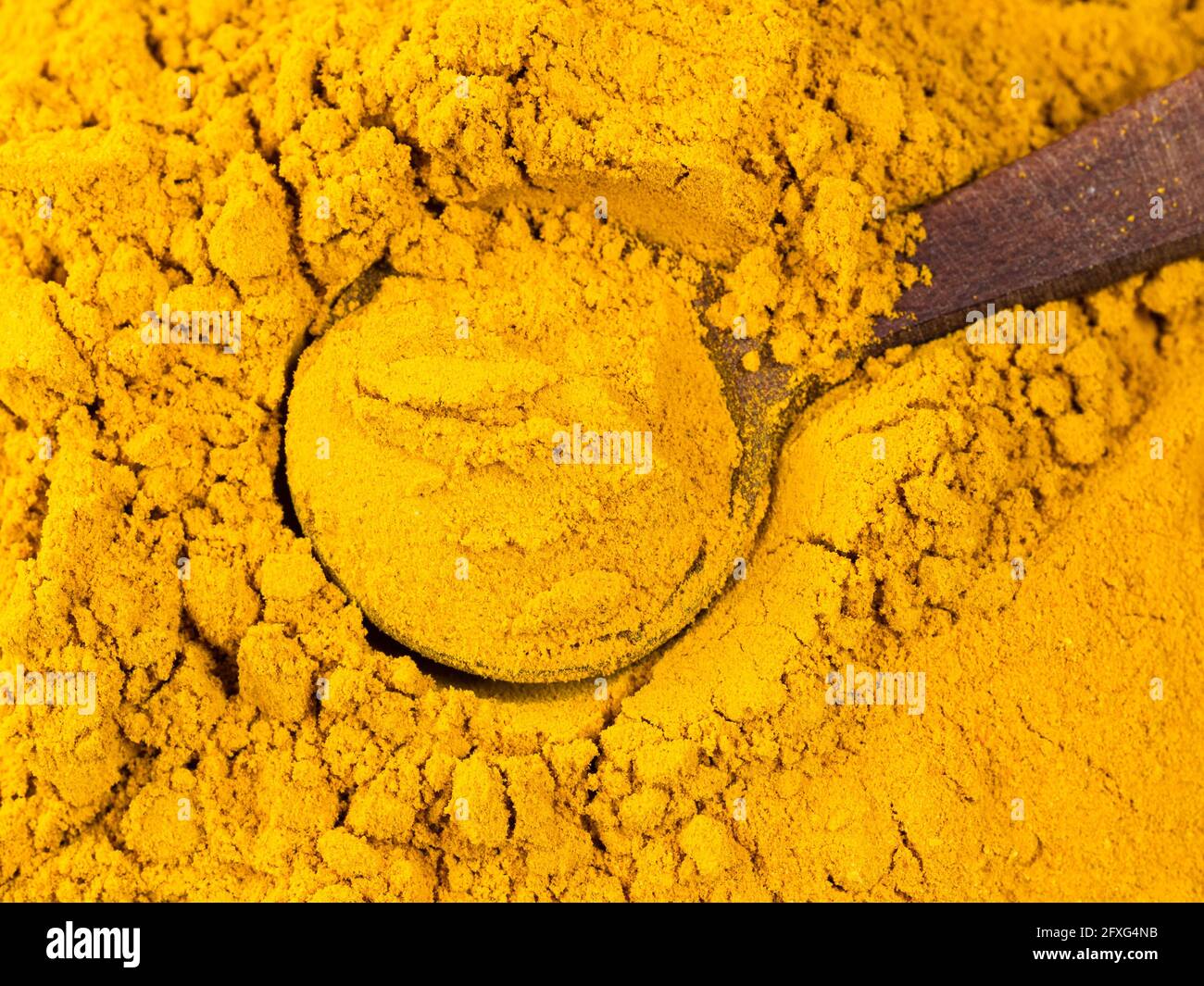 wooden spoon on pile of Turmeric powder (Curcuma Longa) closeup Stock ...
