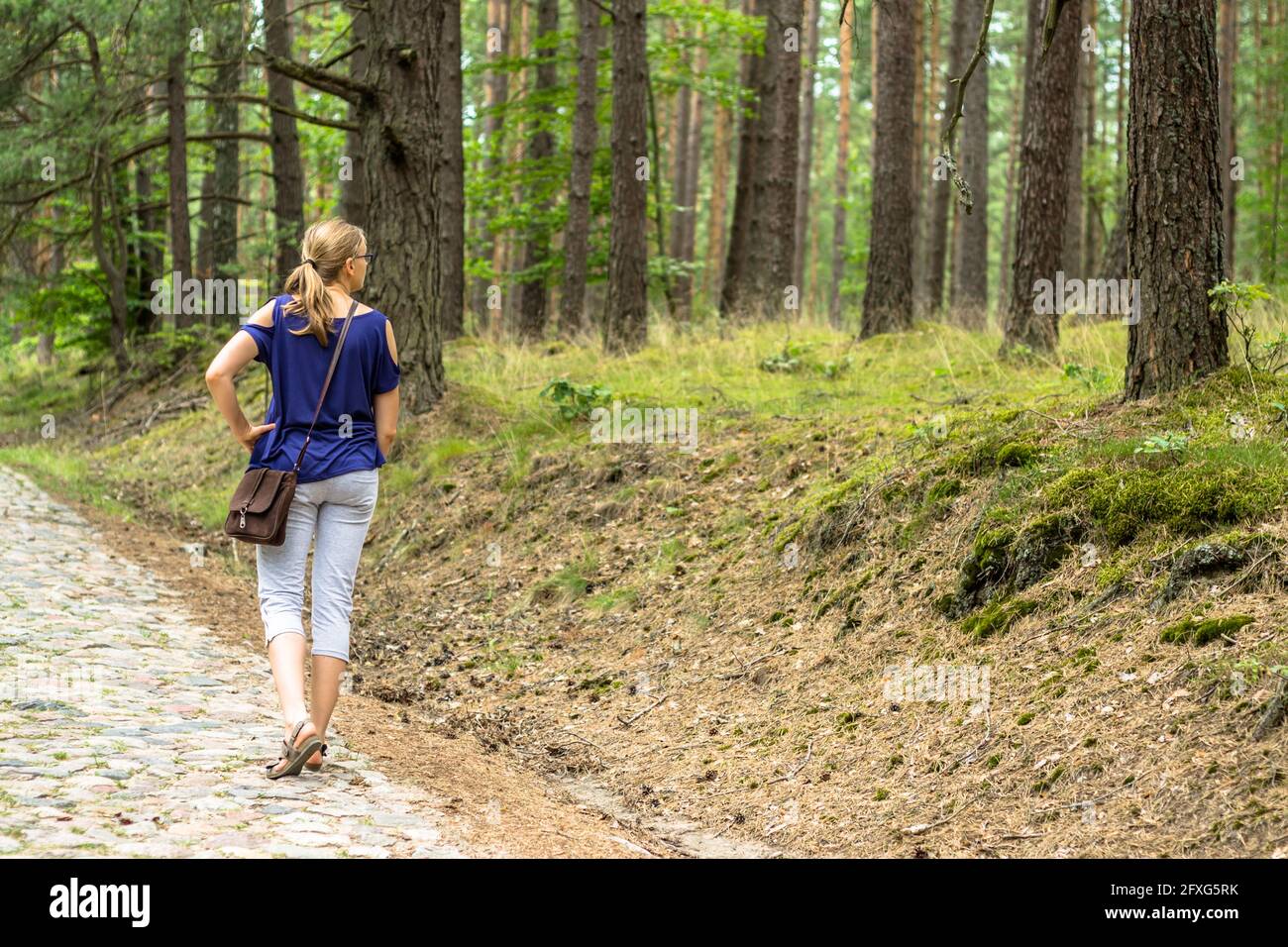 Blonde girl walking through forest hi-res stock photography and images ...