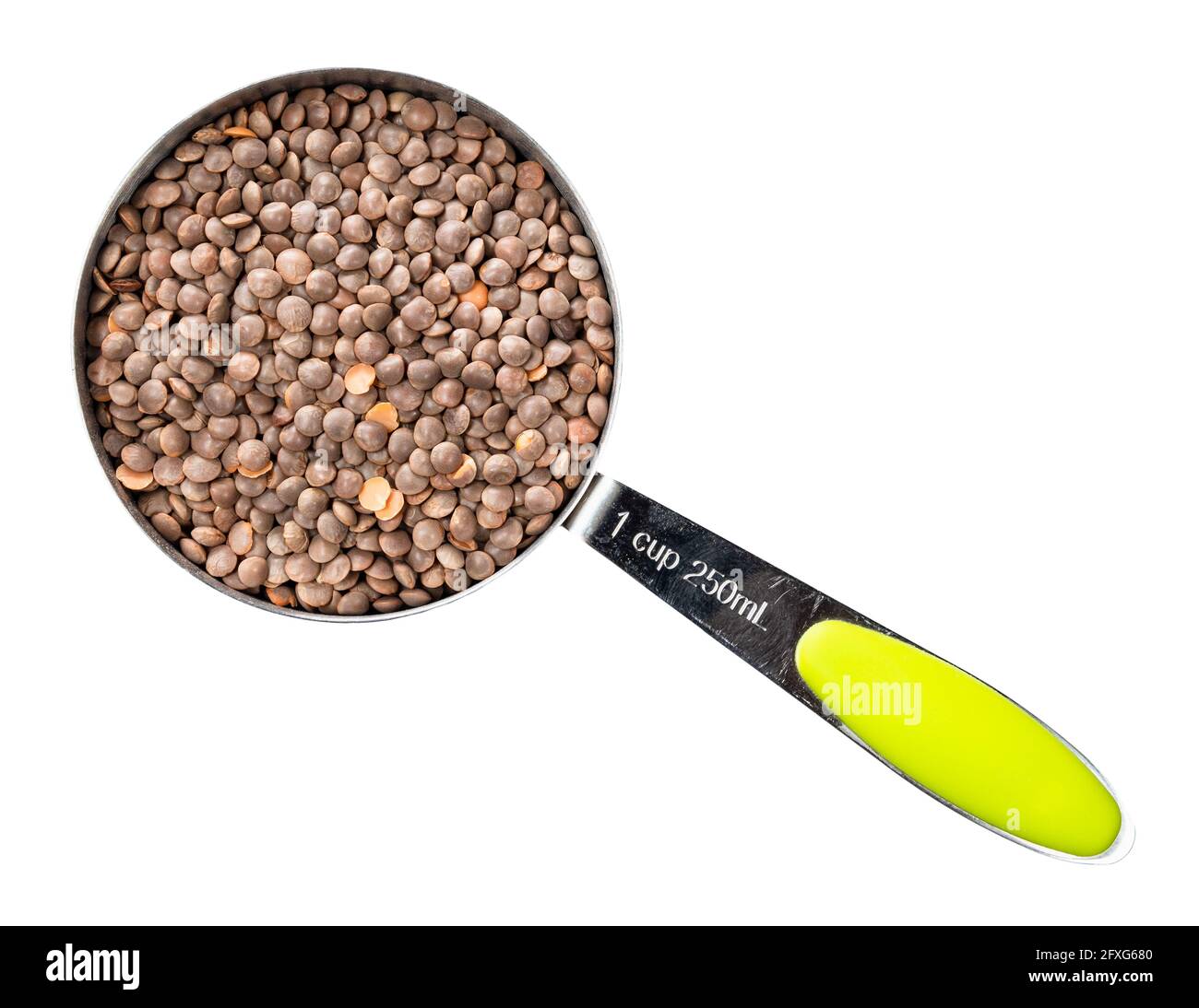 top view of brown unhulled red lentils in measuring cup cutout on white ...
