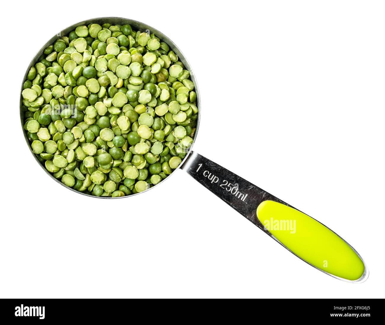 top view of green split peas in measuring cup cutout on white ...